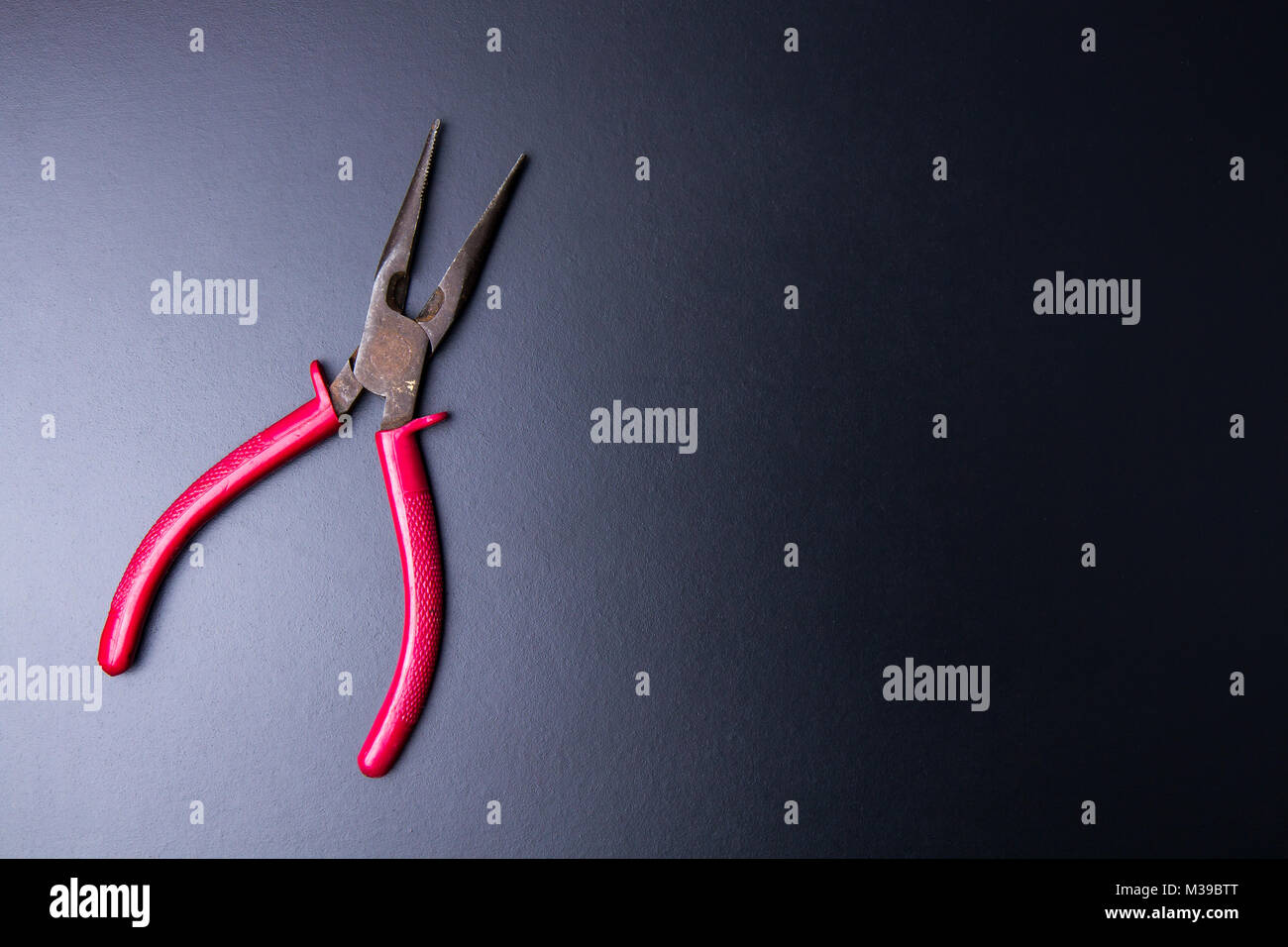 Wire cutters construction tools on a black background with light copy ...