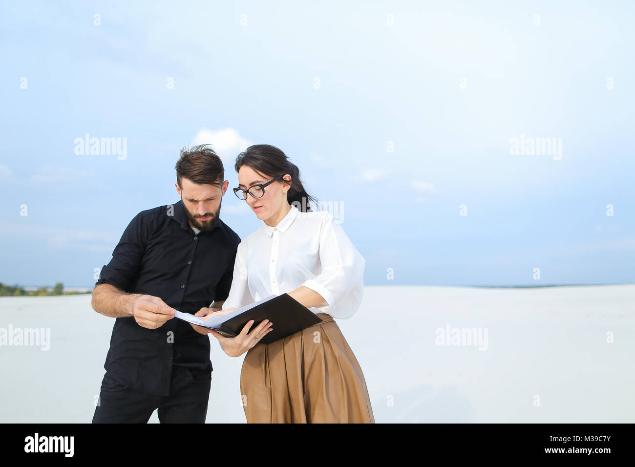 Landscape designer woman showing sketches to customer man Stock Photo ...