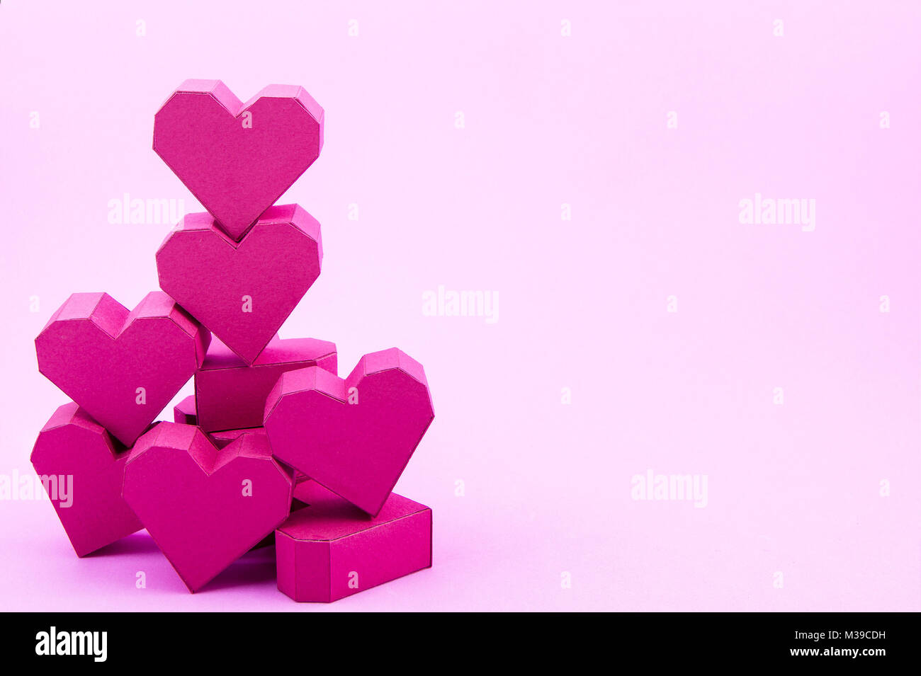 Stack of paper box red heart shape on pink background with copy space ...