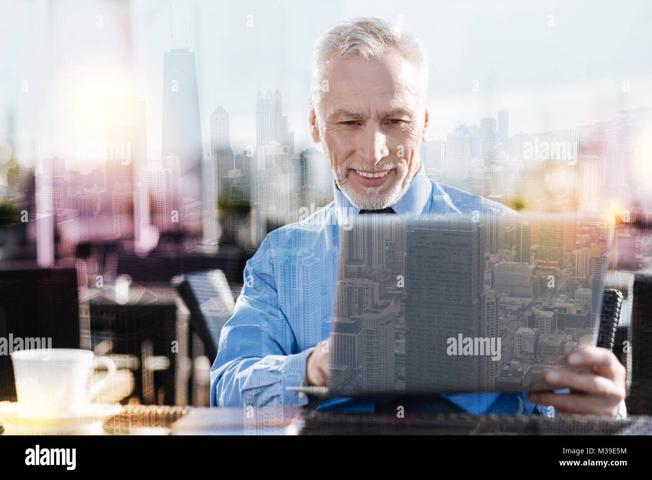 Cheerful man feeling happy while looking at the screen of a laptop ...