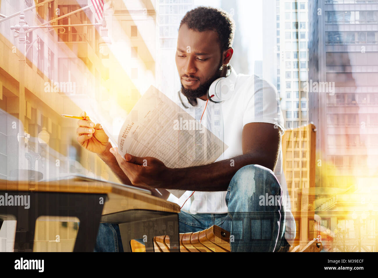 Smart diligent student looking concentrated while preparing for the ...