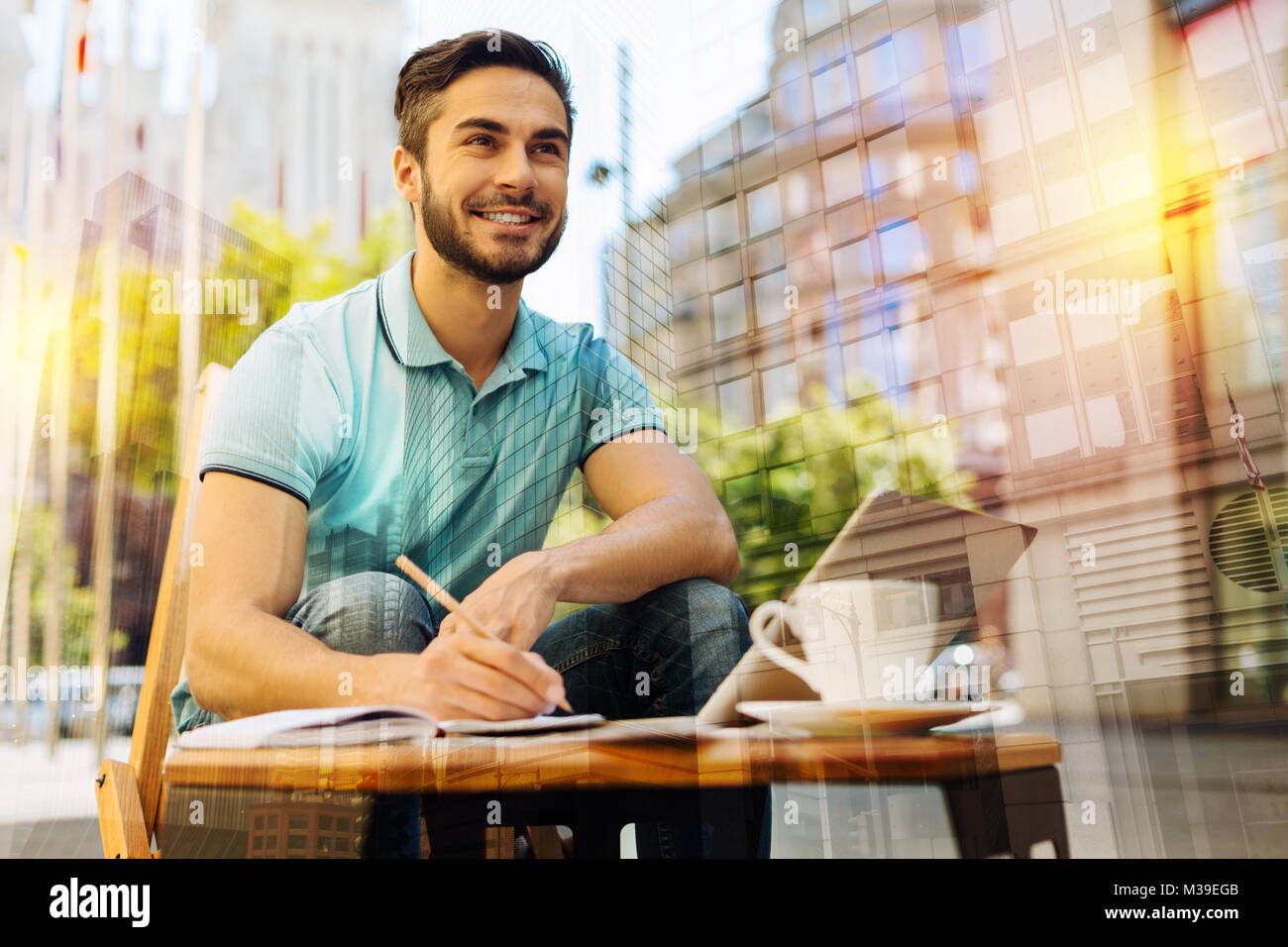 Emotional student feeling glad while making notes and enjoying the ...
