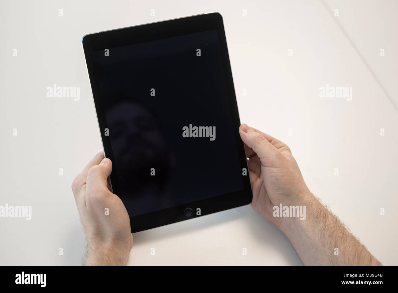 male and female mens and womens hands using an ipad computer tablet for ...