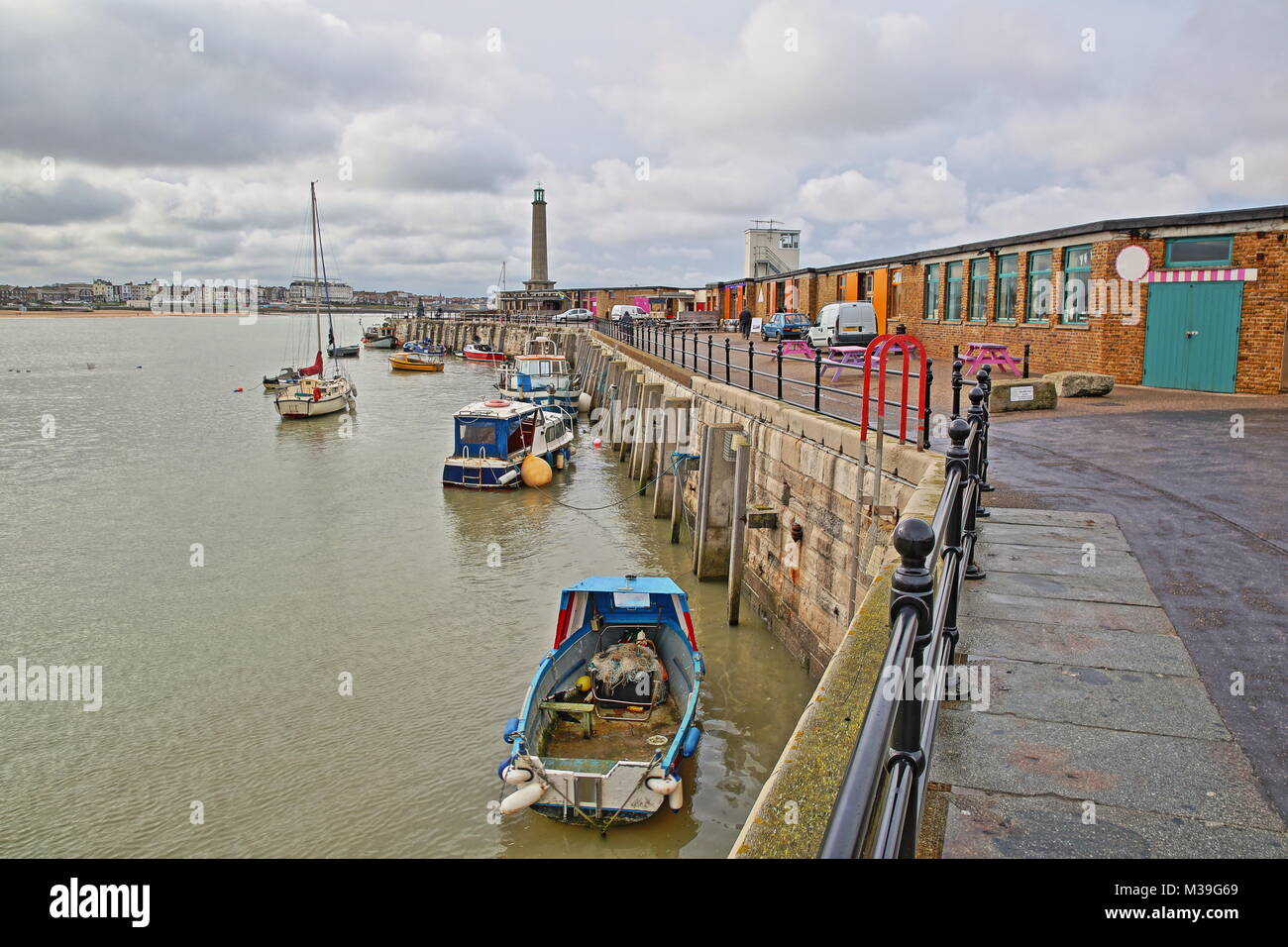 Margate Harbor Arm with mooring boats and the lighthouse in the ...