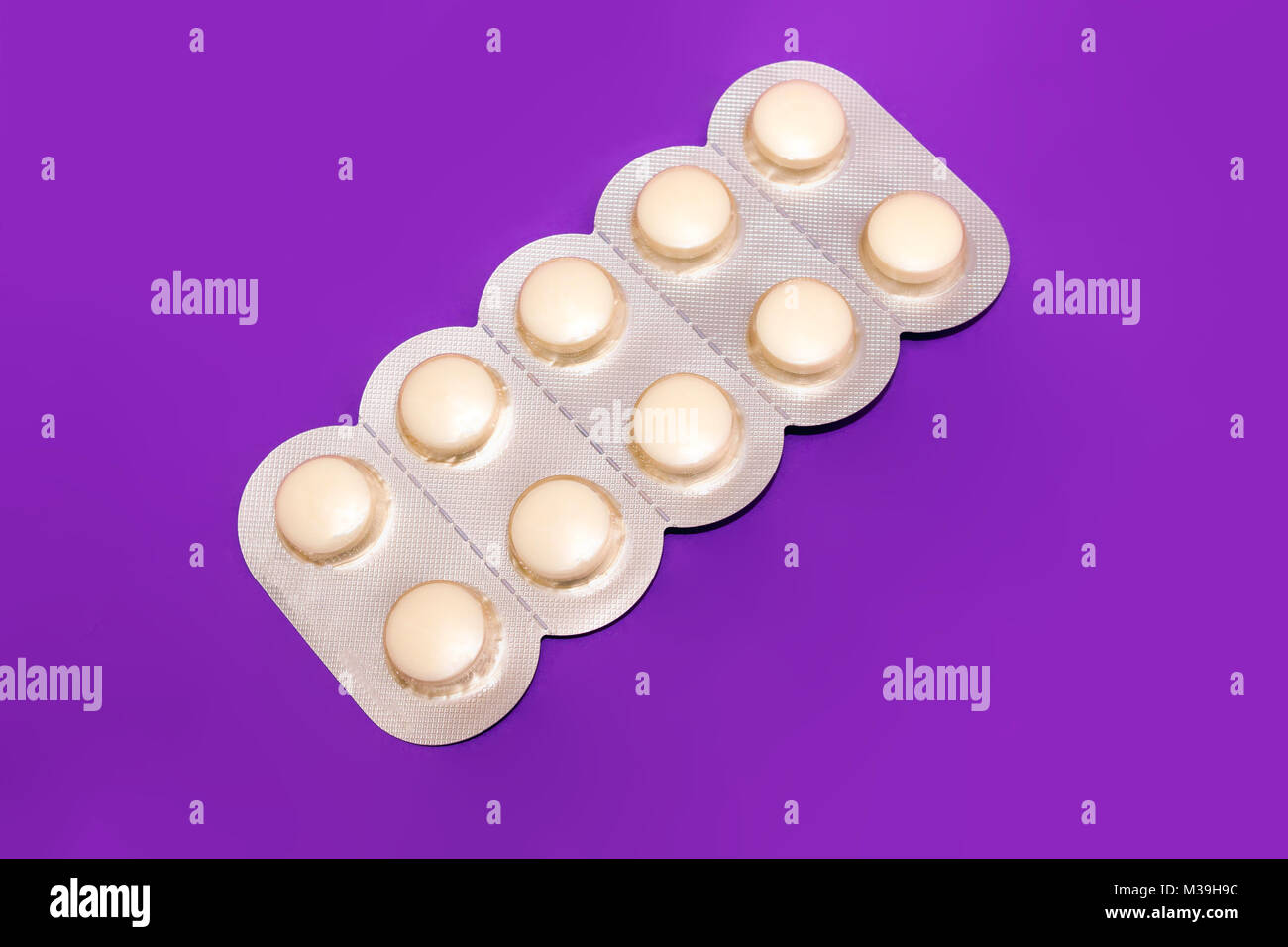 The pill blister pack on a purple background Stock Photo - Alamy