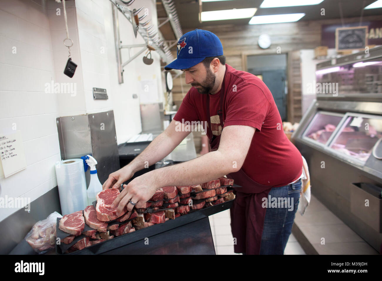 A Sanagan's Meat Locker employee works at the business' Kensington ...