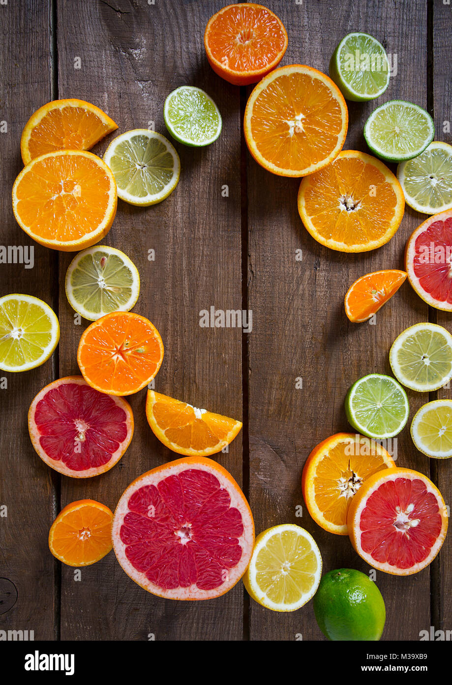 mixed citrus fruits on dark wooden background Stock Photo - Alamy