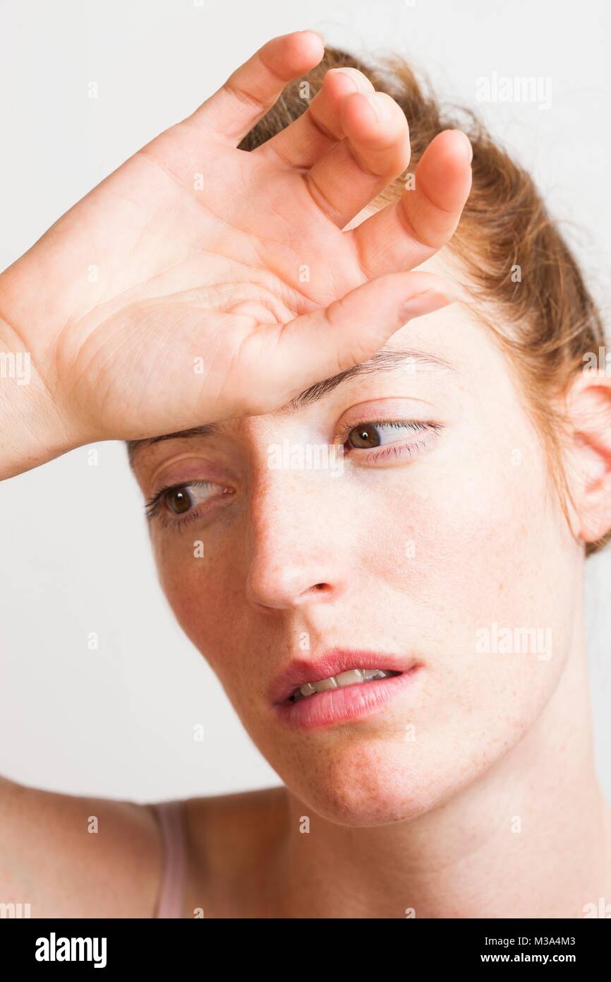 MODEL RELEASED. Woman touching her forehead with hand Stock Photo - Alamy