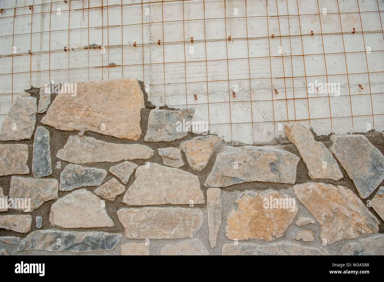 Coating with stones to make aesthetic wall Stock Photo - Alamy