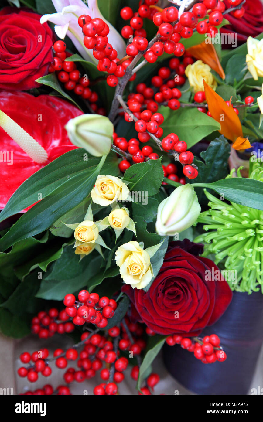 Flower arrangement detail with red roses and berries Stock Photo - Alamy