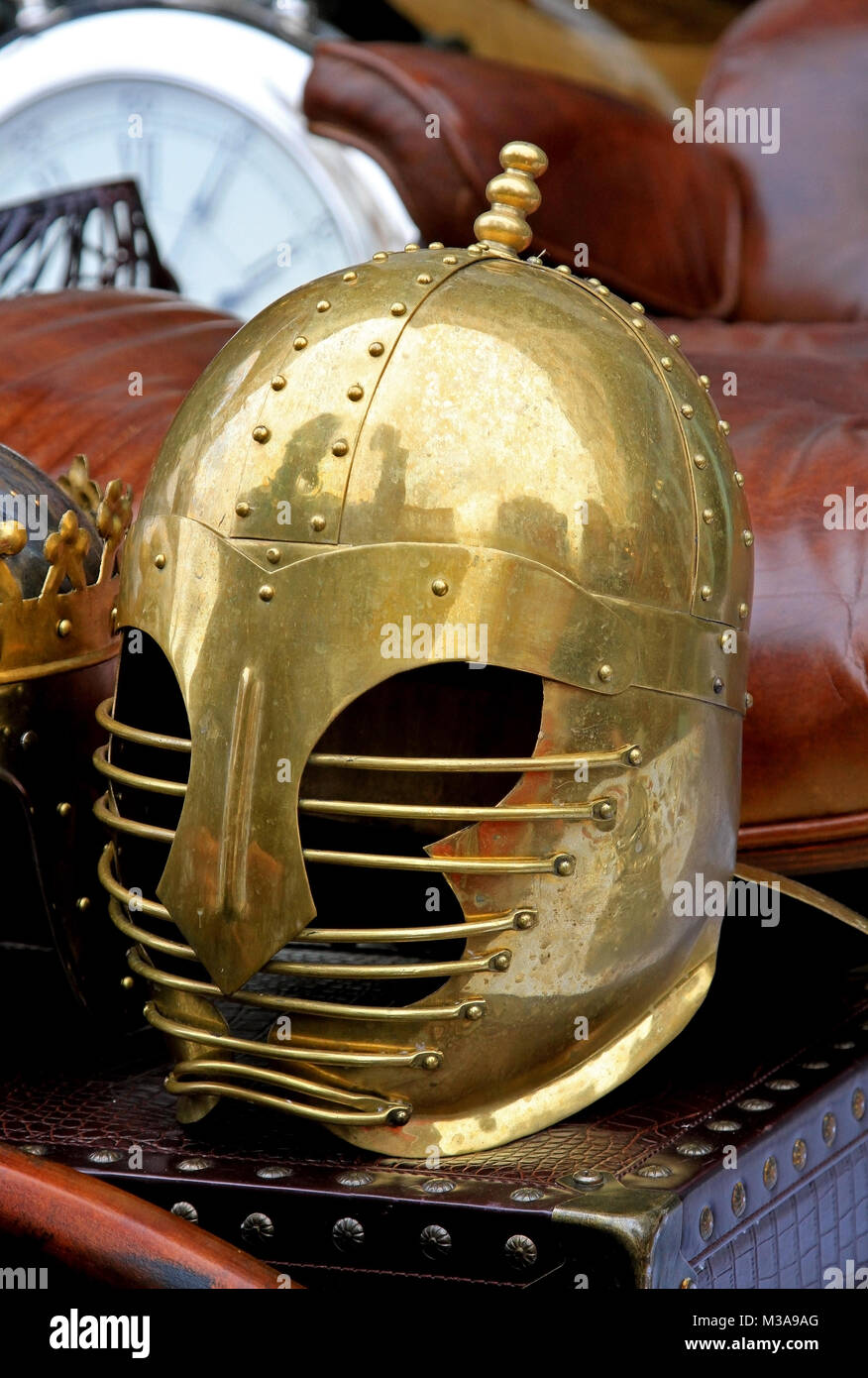 Ancient old gold armor helmet with decorative top Stock Photo - Alamy