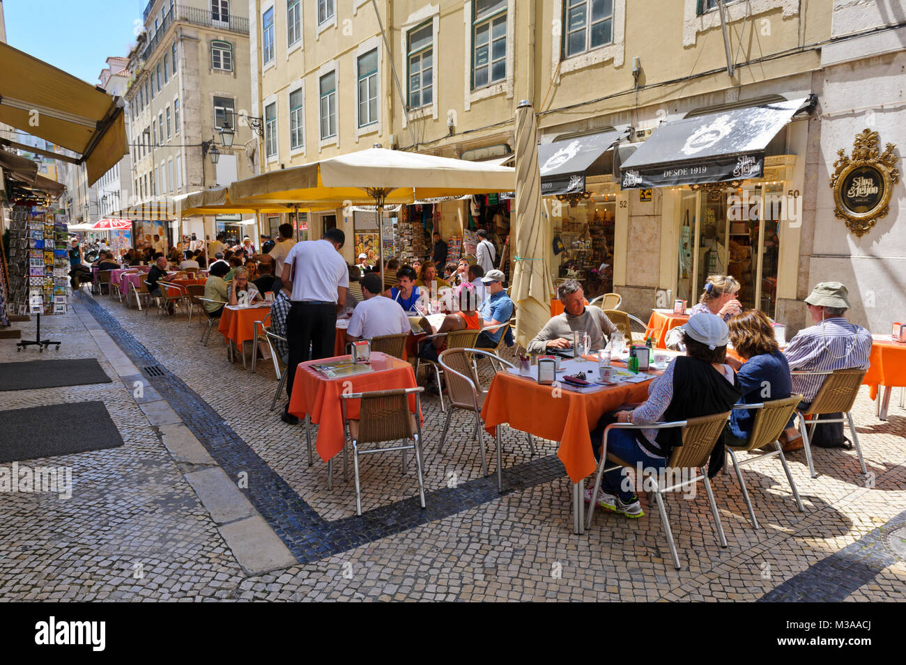 People sitting outside a cafe in Lisbon, Portugal Stock Photo - Alamy