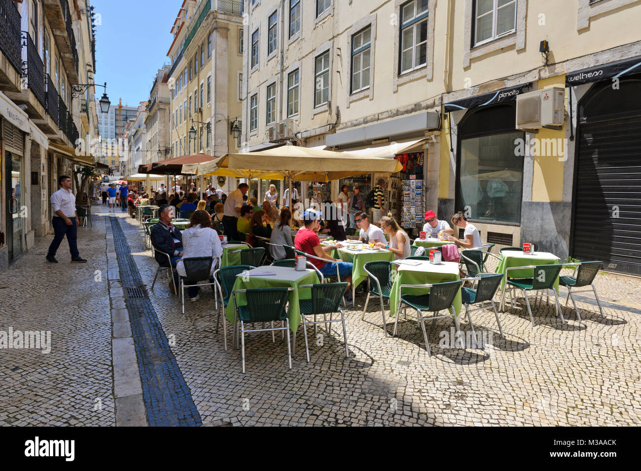 People sitting outside a cafe in Lisbon, Portugal Stock Photo - Alamy
