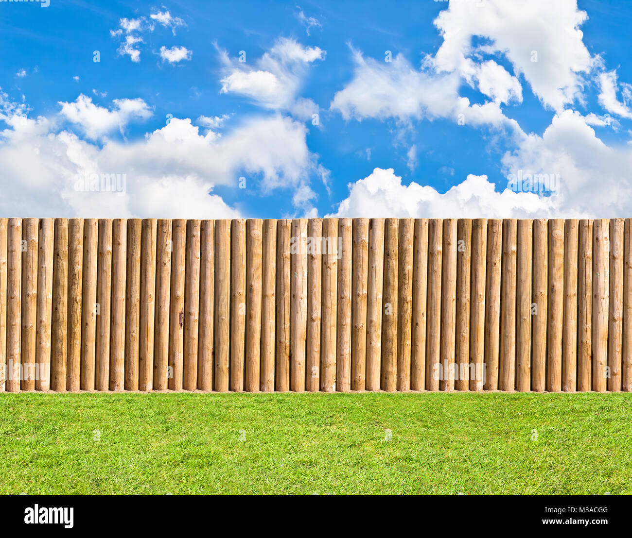 half round post and rail fence with skies and green lawn horizontal ...