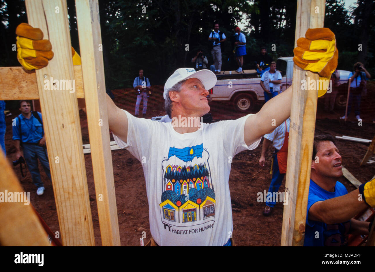 President Bill Clinton works to frame a house during a Habitat for ...