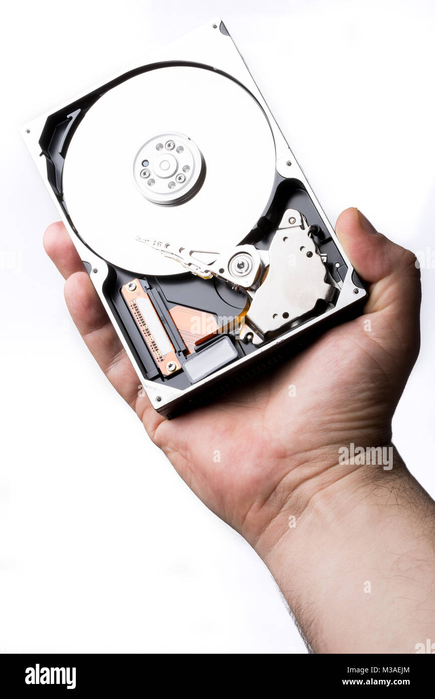 Male technician hand holding computer hard drive over white background ...