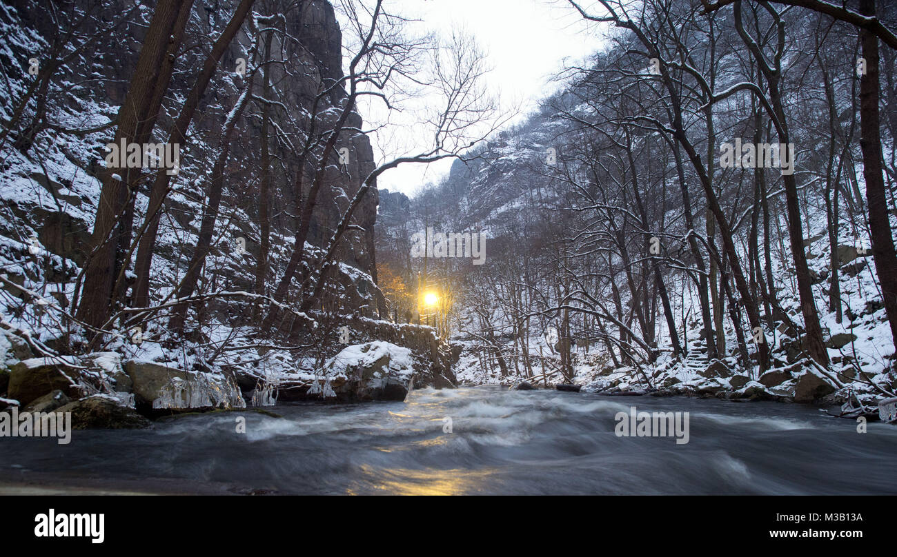 The water of the River Bode flows to the valley through the snow ...