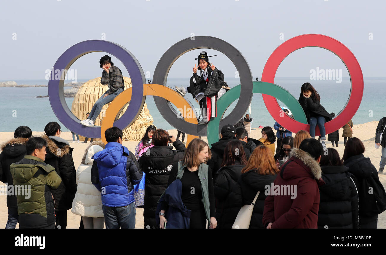 10th Feb, 2018. Olympic emblem sculpture People take photos at a ...