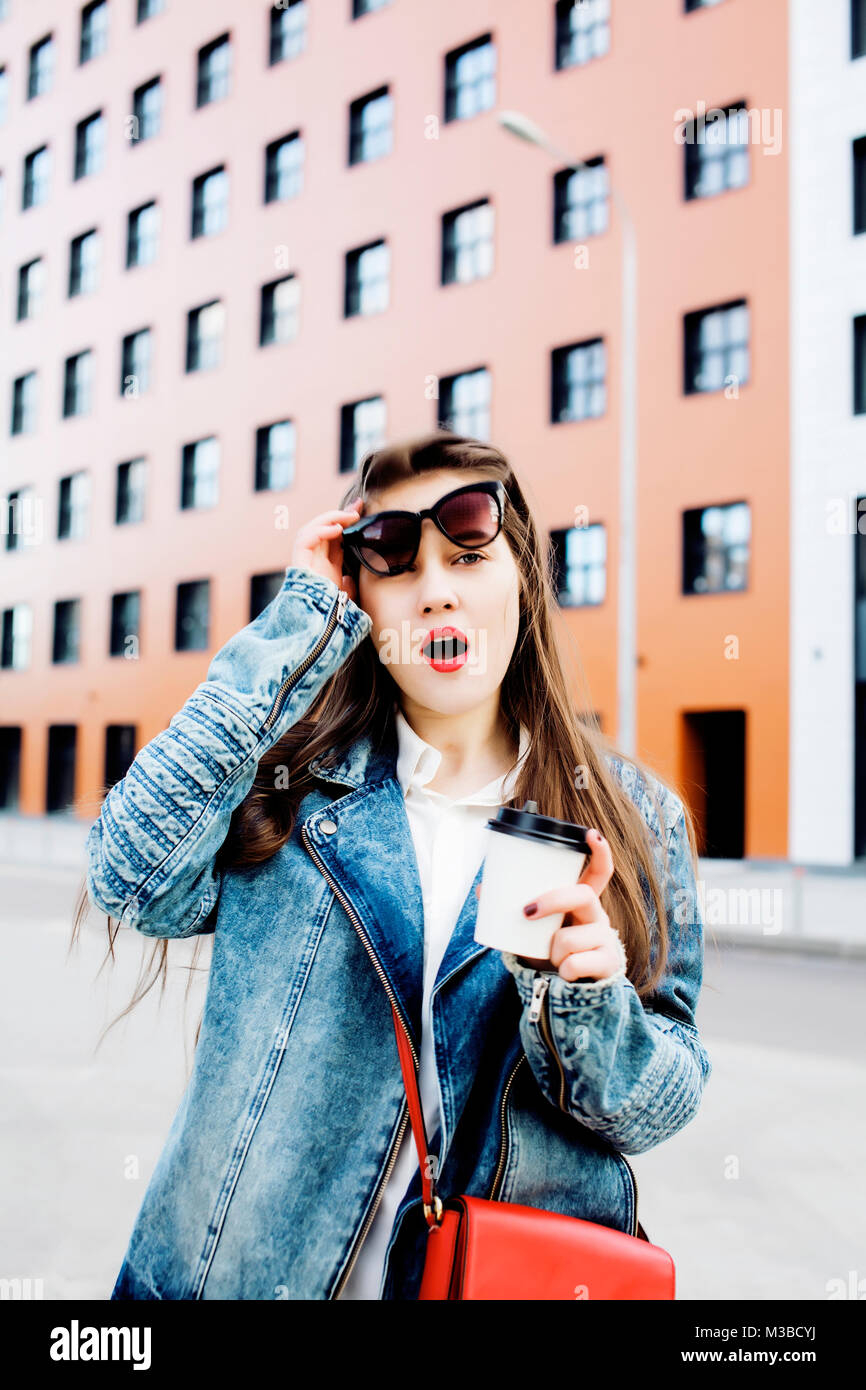 young pretty brunette business woman posing against modern build Stock ...