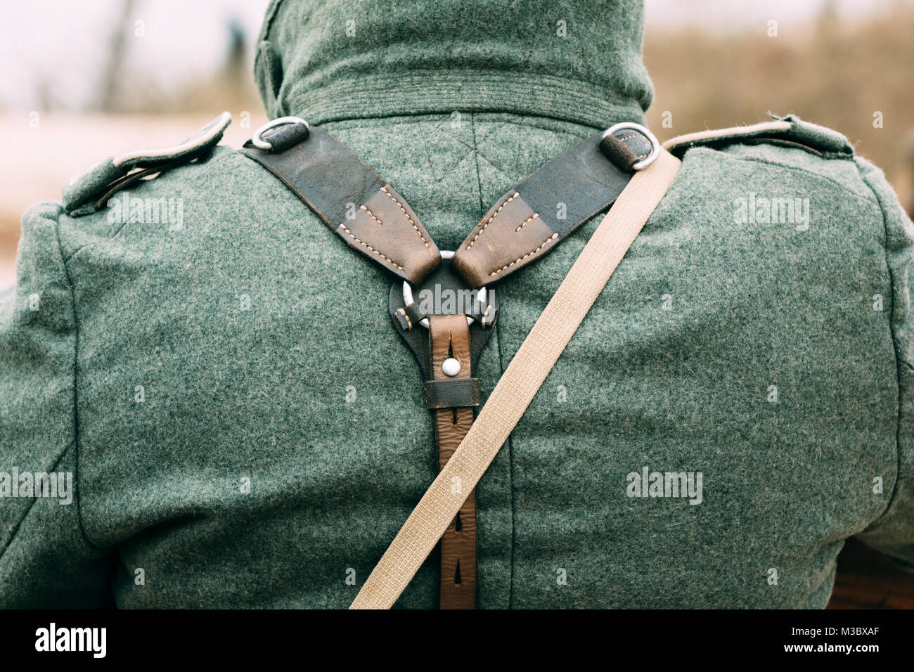 Belts on uniforms and outfits on the back of a German soldier during ...