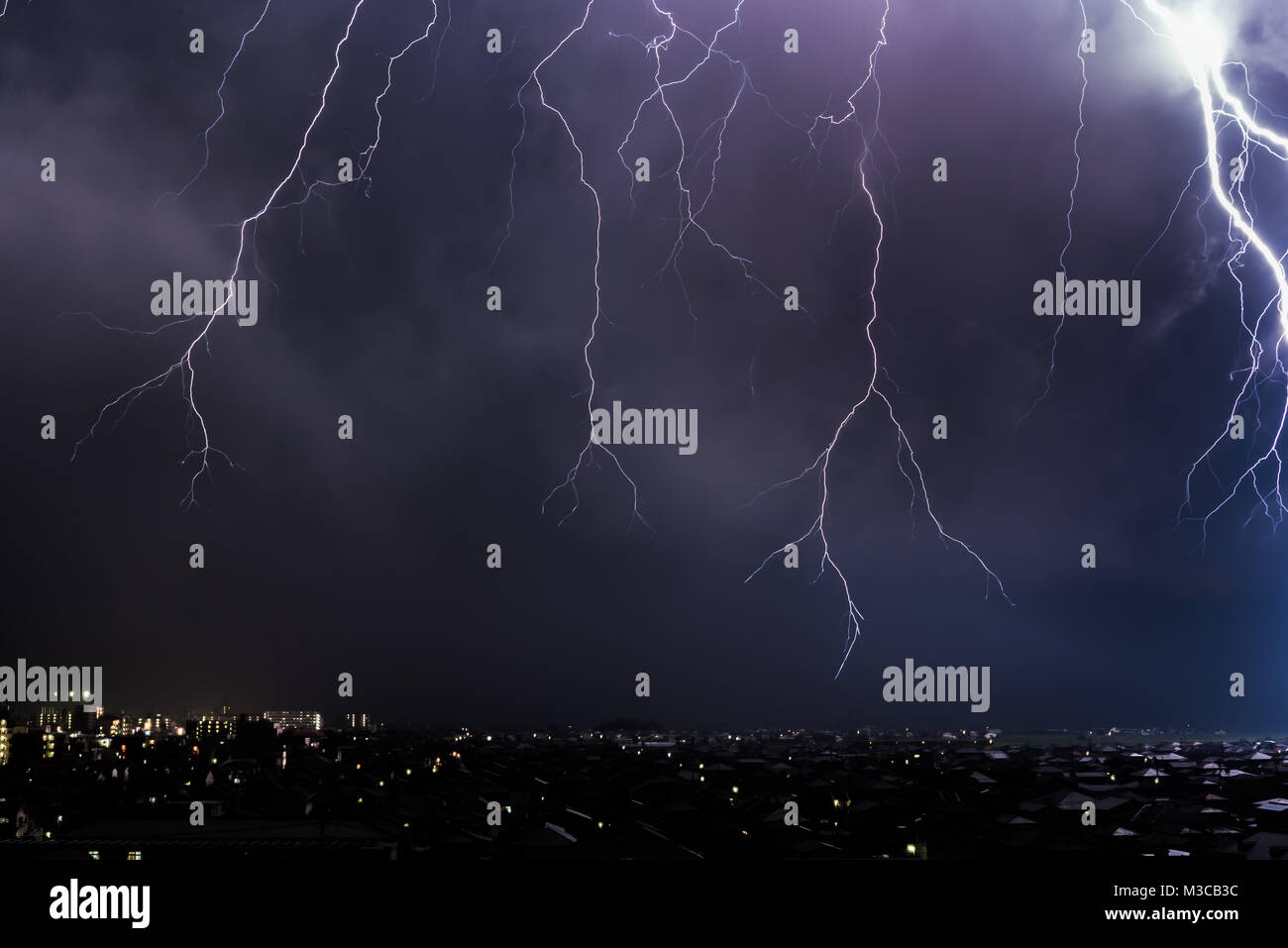 Lightning over City landscape Stock Photo - Alamy