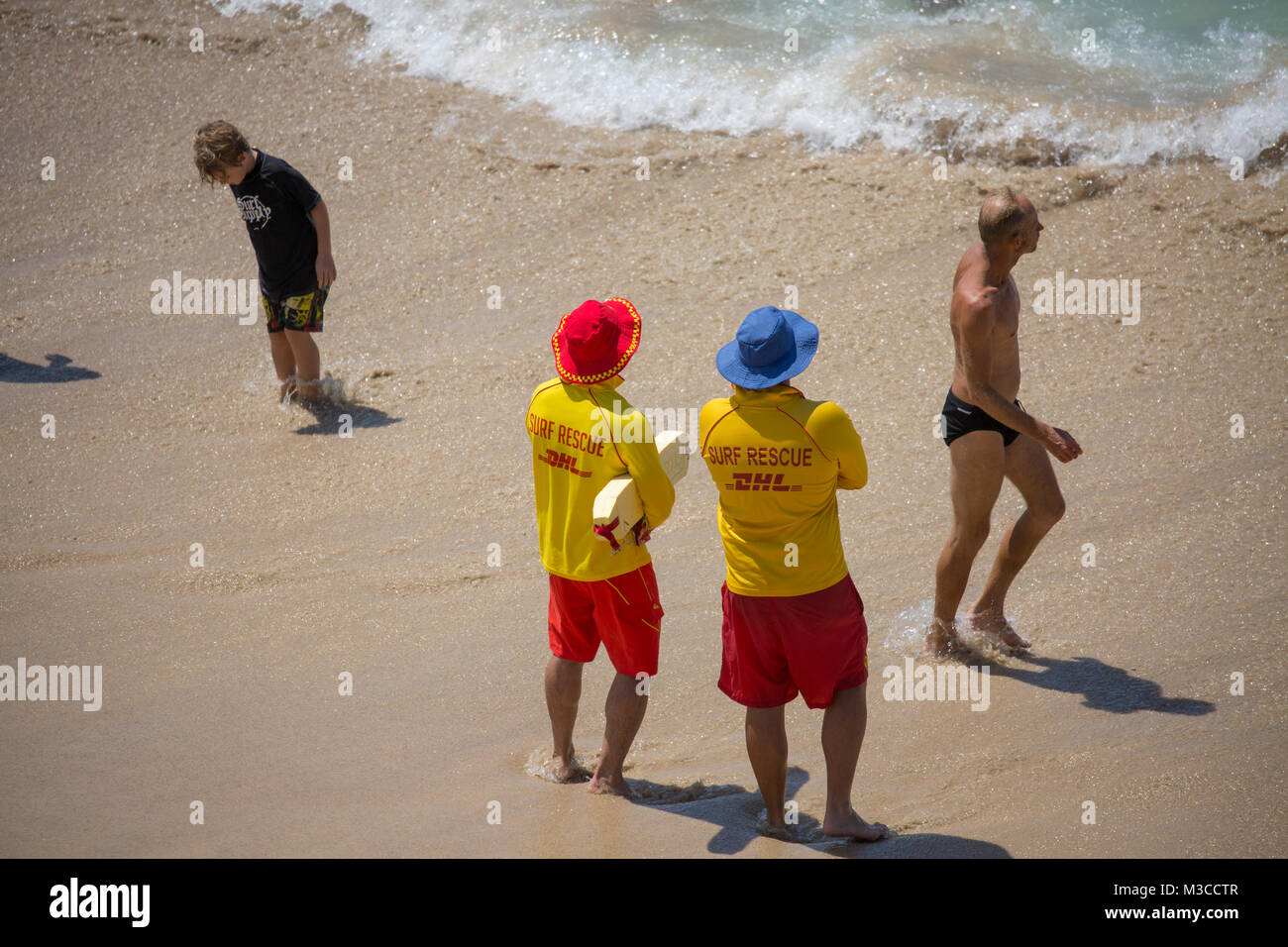 Two surf rescue lifeguards watching people in the ocean at Tamarama ...