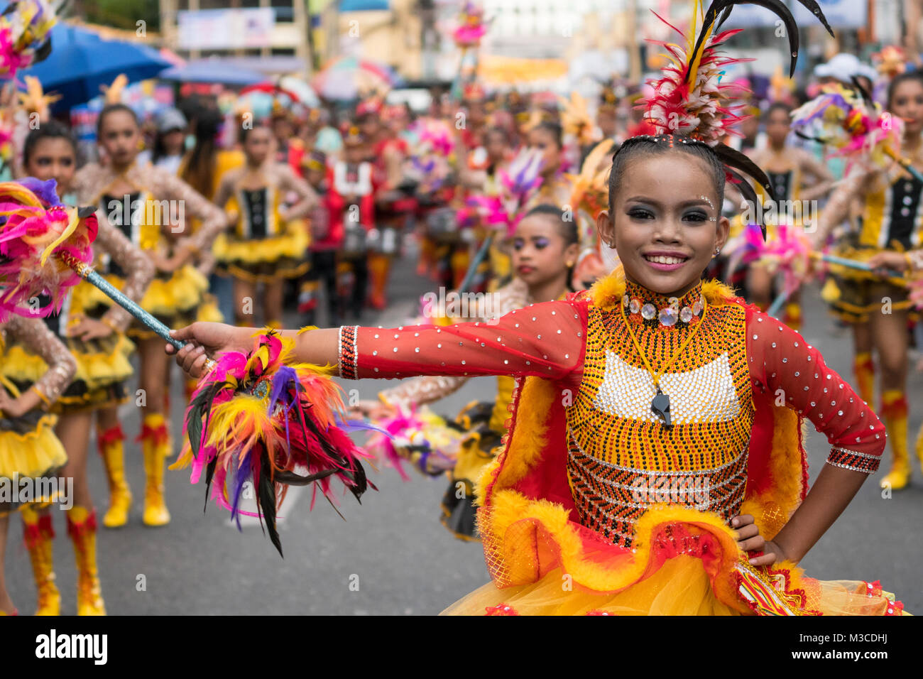 Elementary school girls taking part in a street procession as part of ...