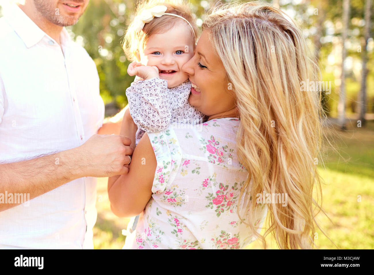 Happy family in a park in summer Stock Photo - Alamy
