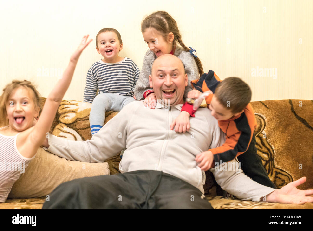 happy dad with four young children. Two girls and two boys. Selected ...