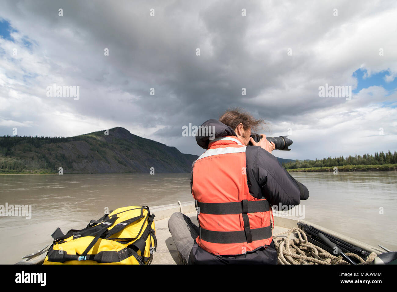 NPS Ranger Dev Dharm photographs from the bow of a river boat on the ...