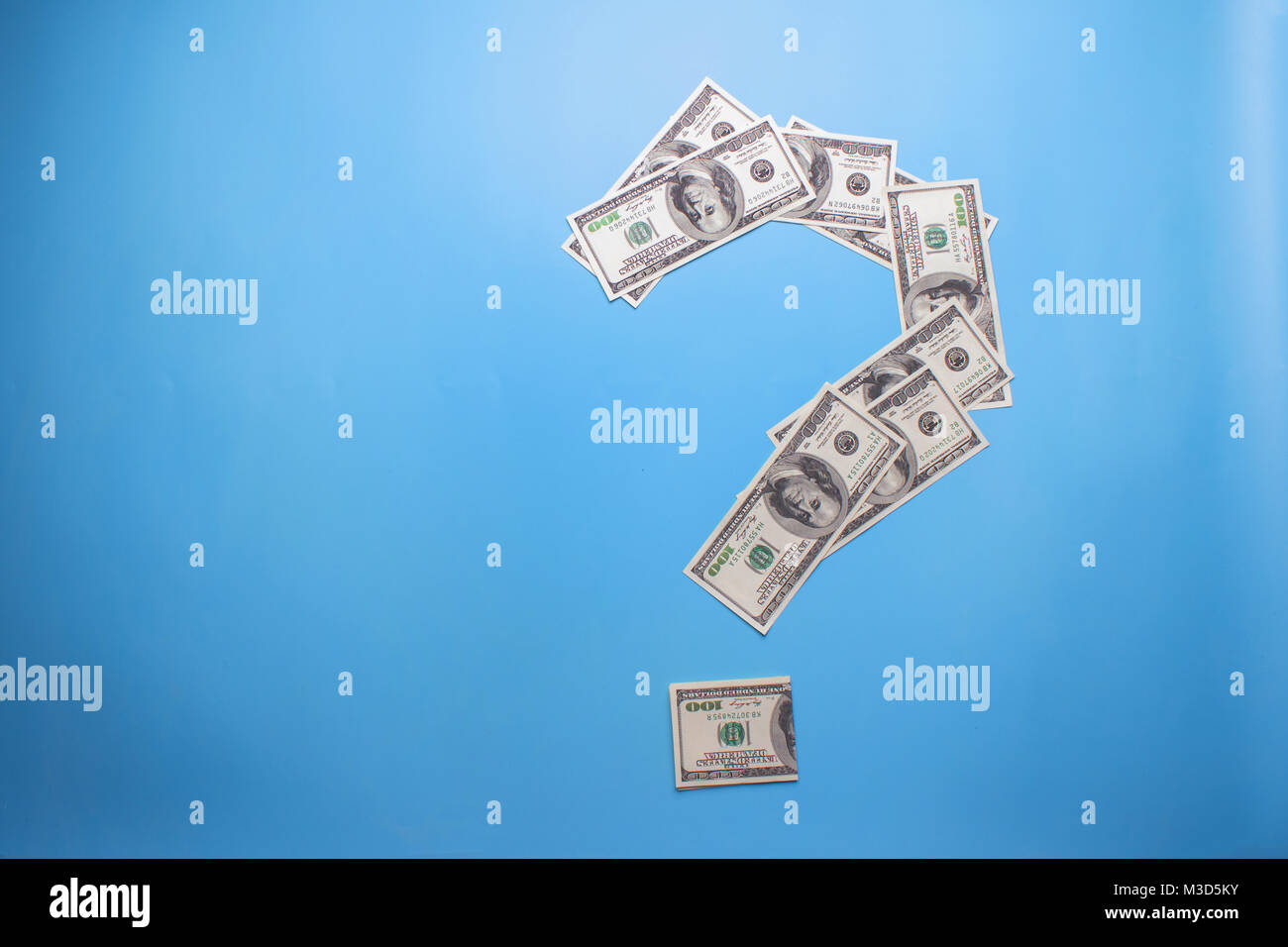 dollar in a form of question mark on blue background Stock Photo - Alamy