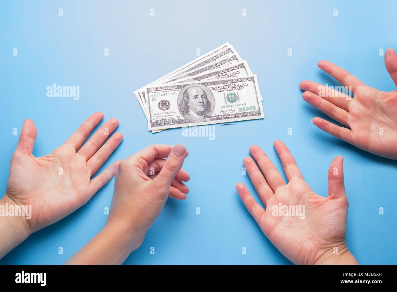 many hands reach for money. borrow money, greed concept Stock Photo - Alamy