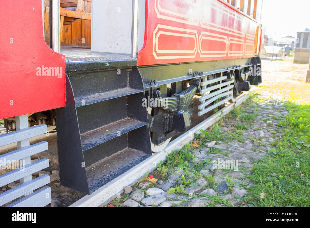 Moving wheels of retro red tram. close up Stock Photo - Alamy