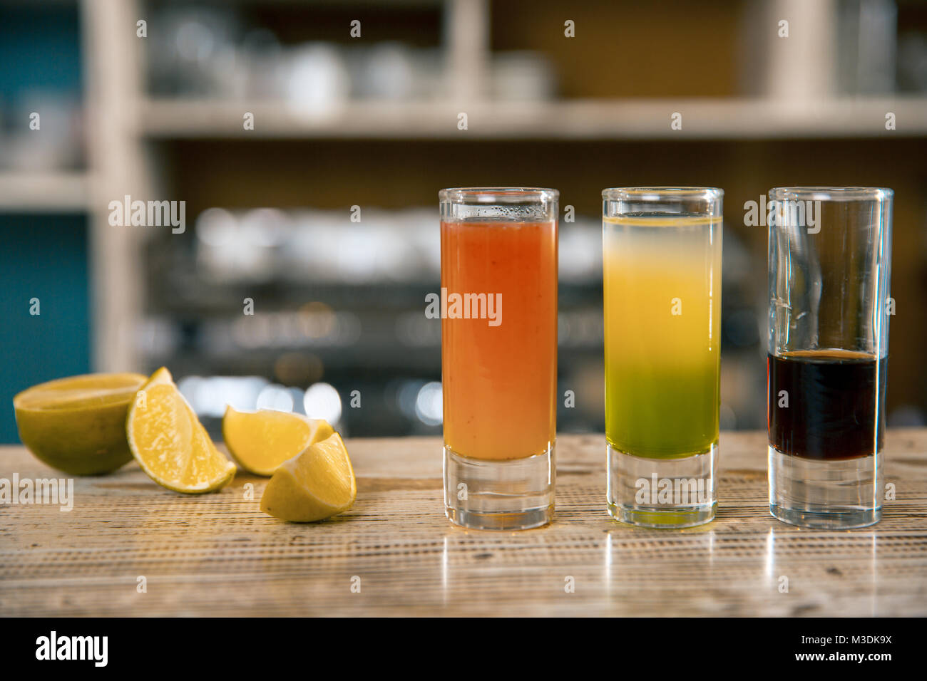 Shooters drinks. Three colorful short cocktail on a bar background ...