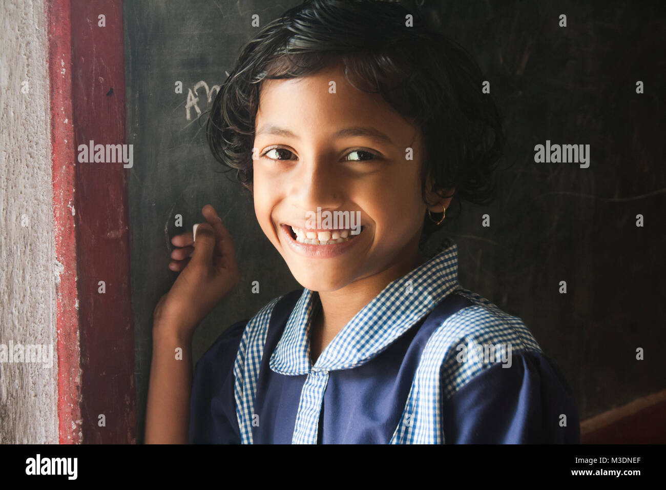 rural student standing in front in black board Stock Photo - Alamy