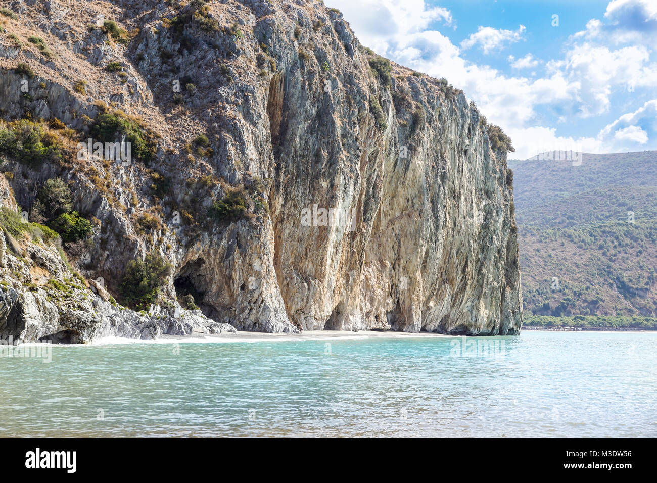 tall sharp cliff shooted from the water near at beach Stock Photo - Alamy