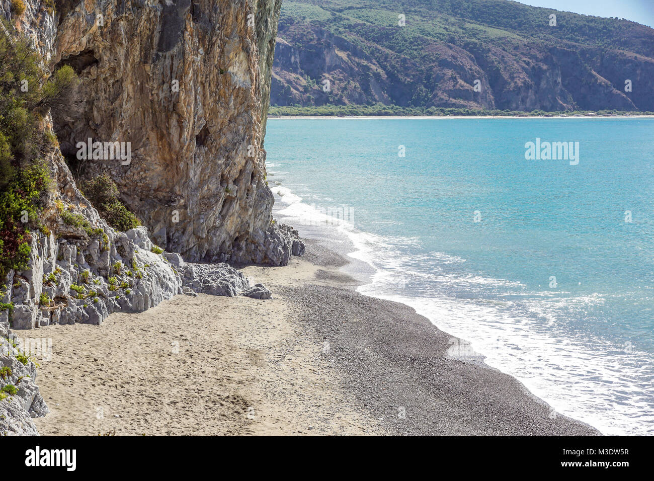 tall sharp cliff shooted from the water near at beach Stock Photo - Alamy