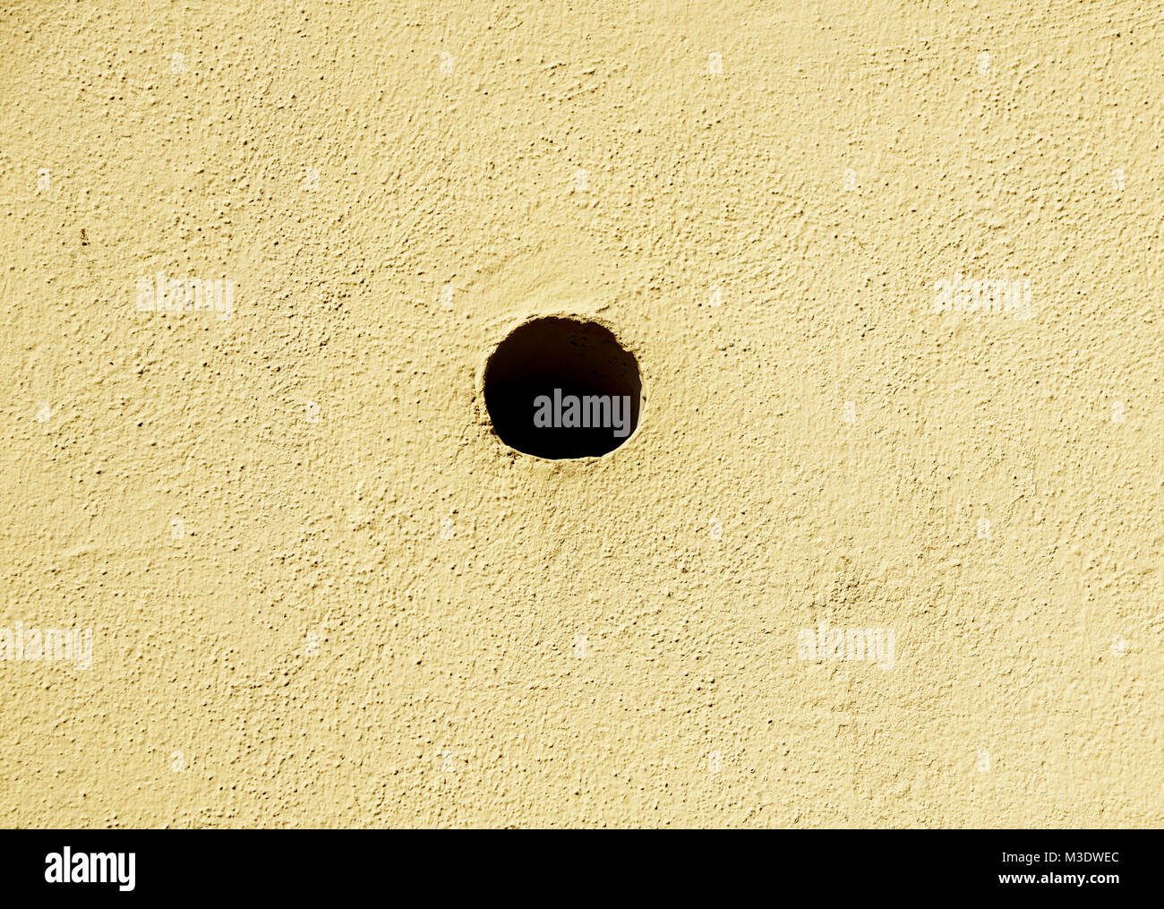 black hole in in white wall as a background Stock Photo - Alamy