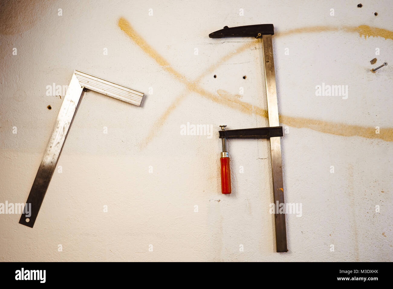 construction ruler and clamps hanging on the wall Stock Photo - Alamy