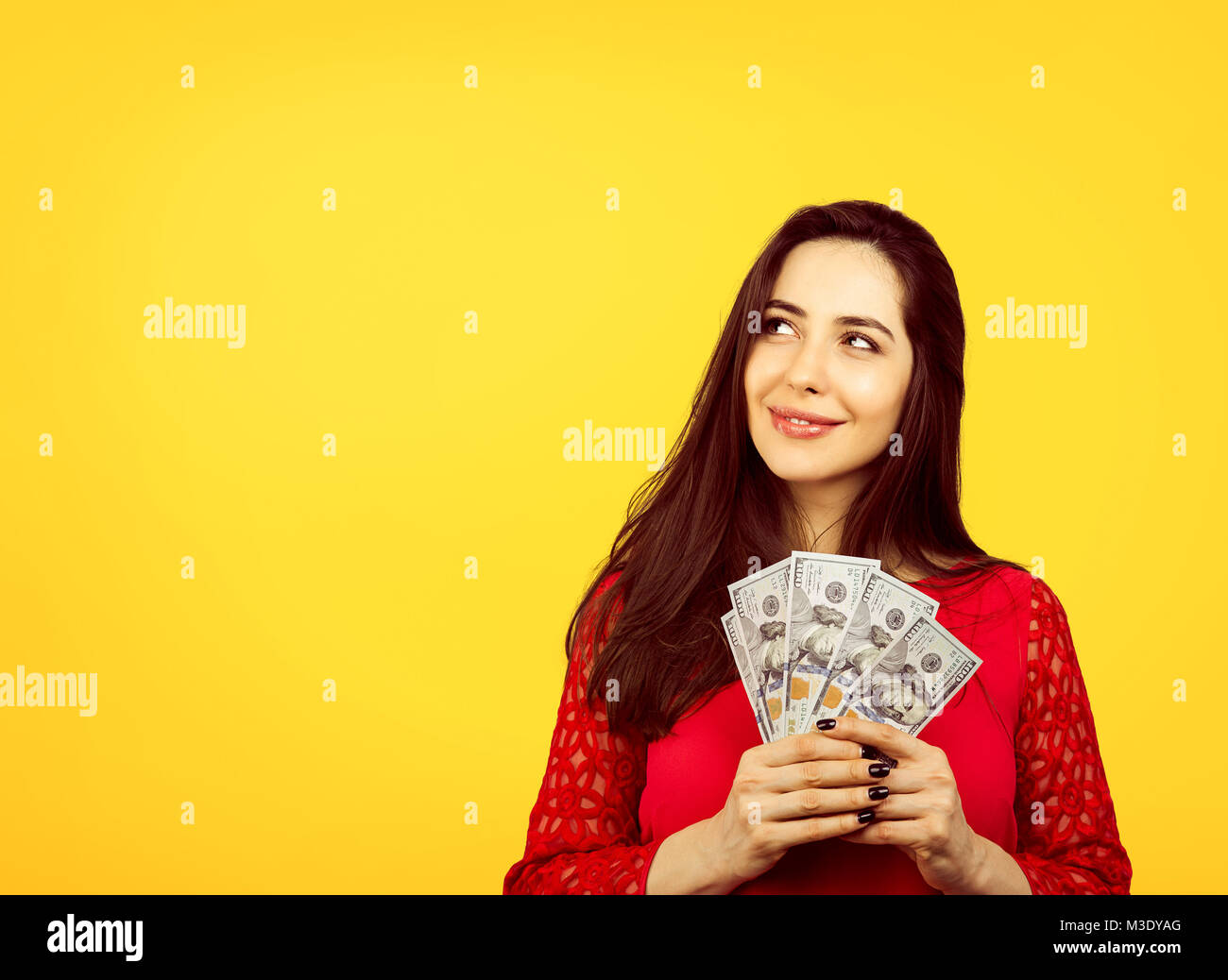 Happy successful young business woman holding money dollar bills in ... Happy successful young business woman holding money dollar bills in ...