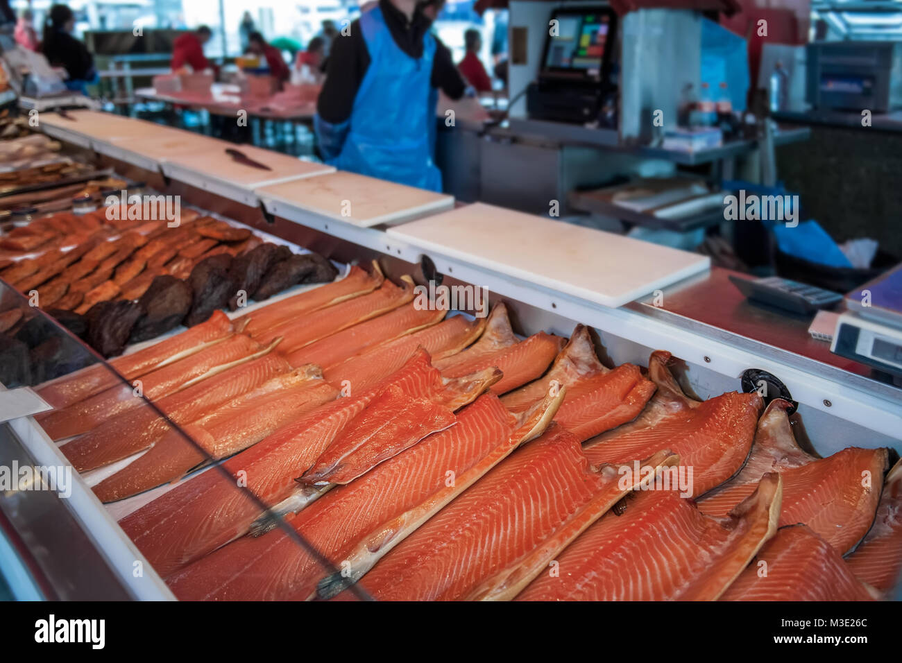 Large showcase with halves of delicious fish of the North sea trout ...