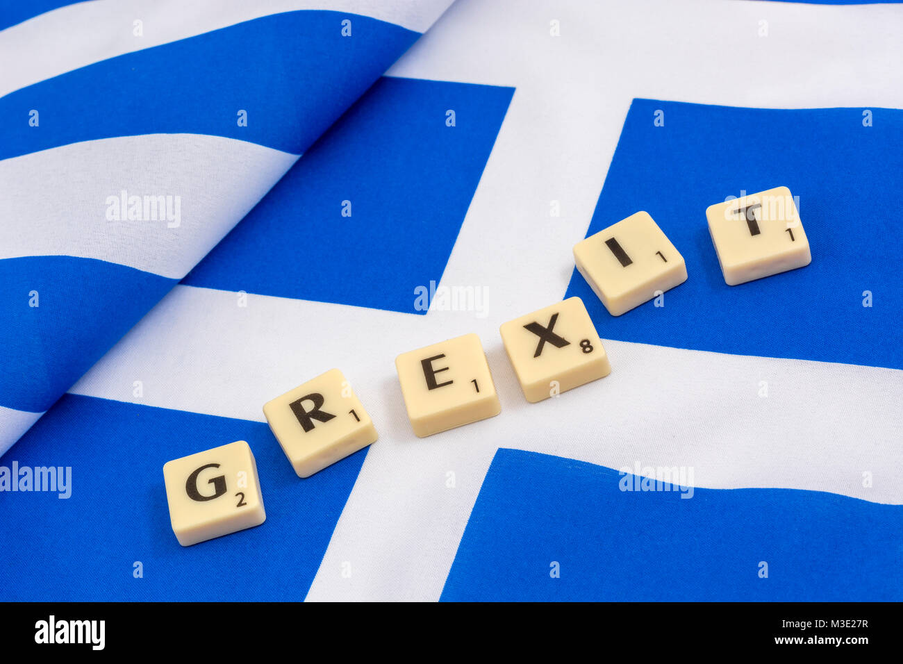 Greek flag and alphabet tiles spelling GREXIT Stock Photo - Alamy
