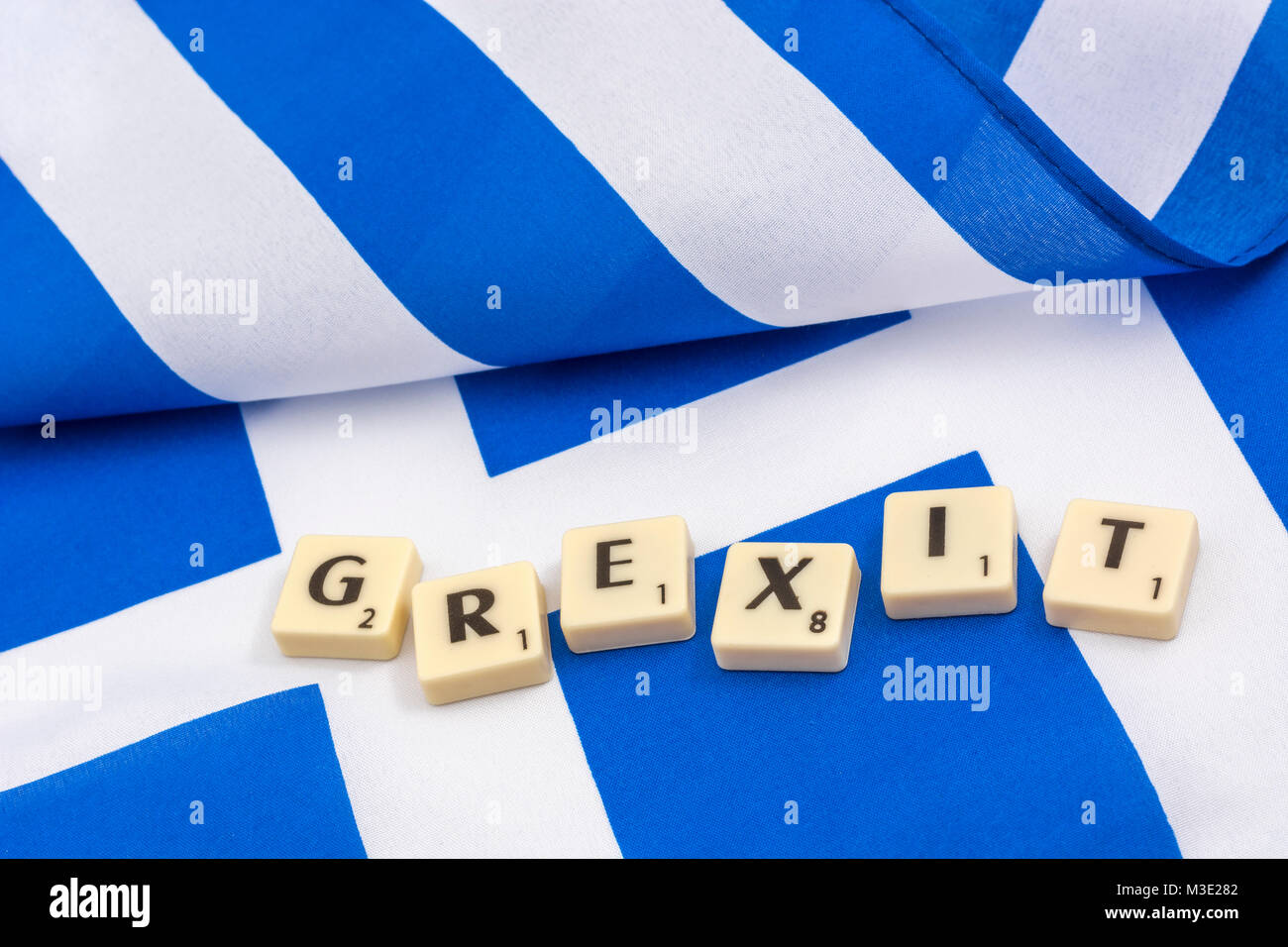 Greek flag and alphabet tiles spelling GREXIT Stock Photo - Alamy