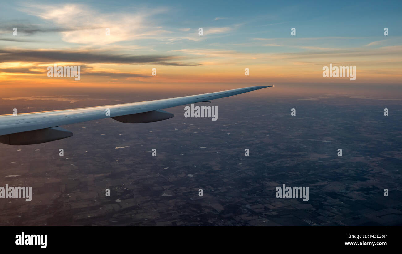 Looking outside of Airplane Window During Sunset Stock Photo - Alamy