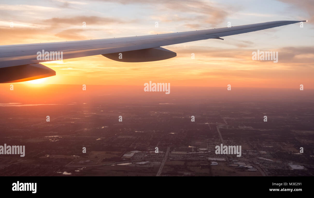 Colorful Skies Outside of Airplane Window with City and Roads in the ...