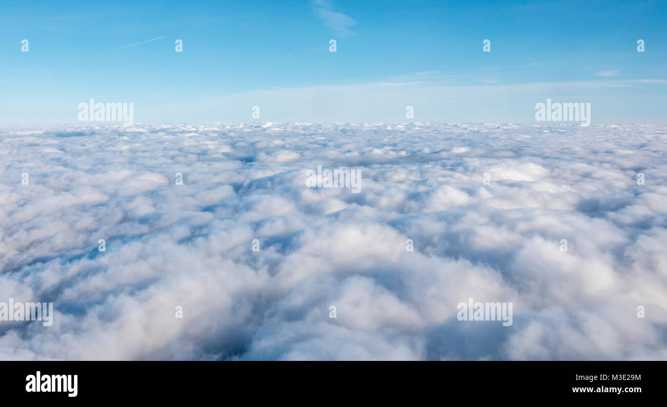 White Dense Cloud Covering with Blue Open Skies Above Stock Photo - Alamy