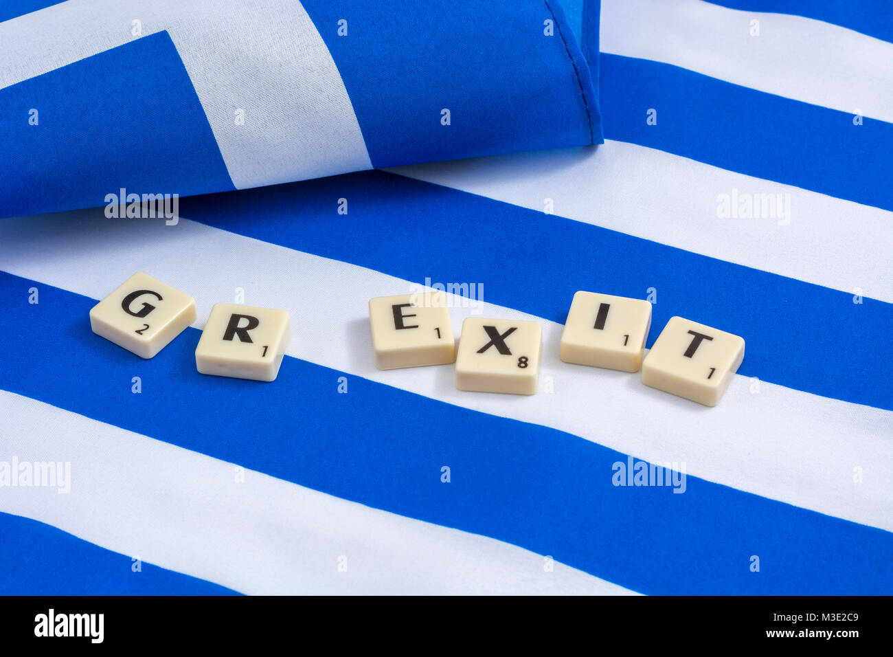 Greek flag and alphabet tiles spelling GREXIT Stock Photo - Alamy