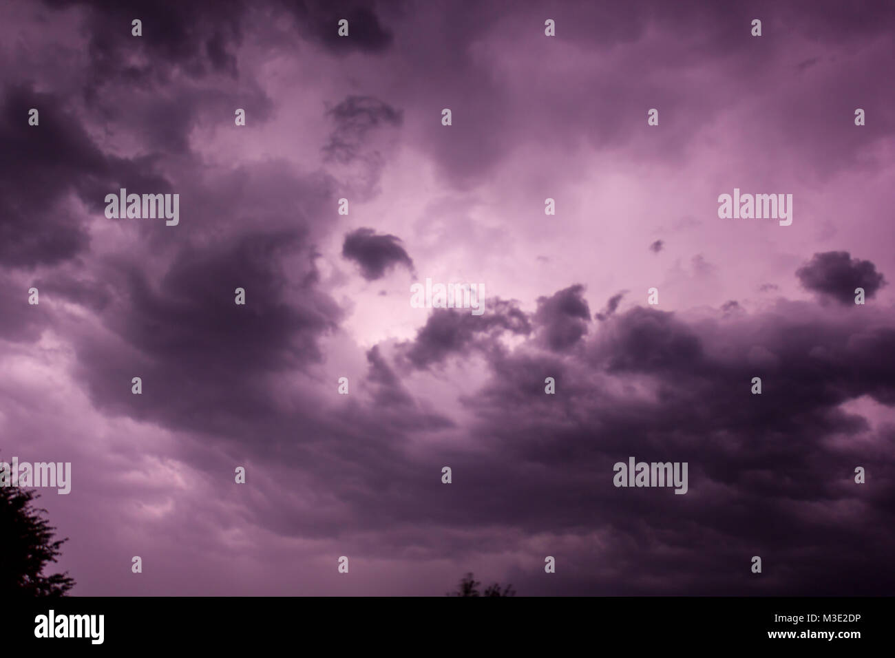 Lightning behind clouds Stock Photo - Alamy