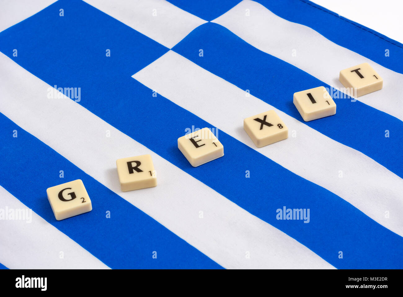 Greek flag and alphabet tiles spelling GREXIT Stock Photo - Alamy