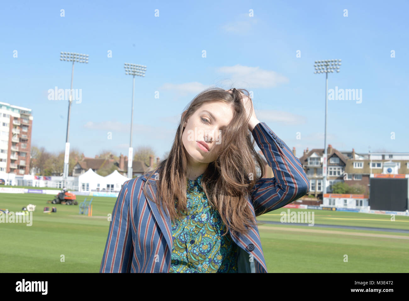 A beautiful girl wearing a tailored stylish patterned suit is at a ...